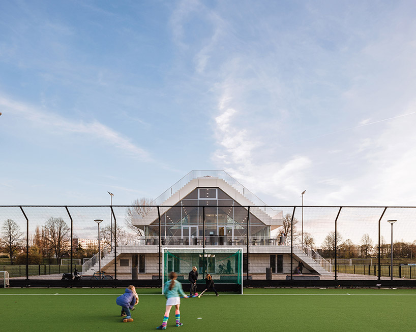 this sports center by NL architects features a pitched roof and grandstand
