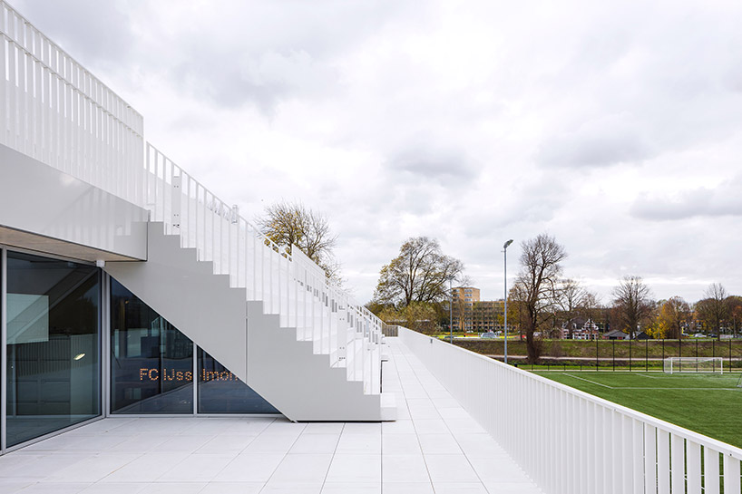 this sports center by NL architects features a pitched roof and grandstand