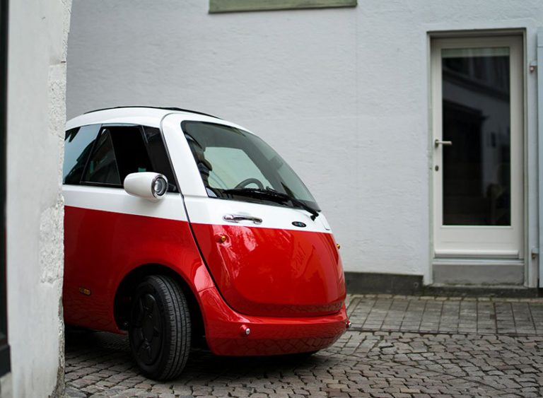 small, electric microlino car soon to be driving along european streets