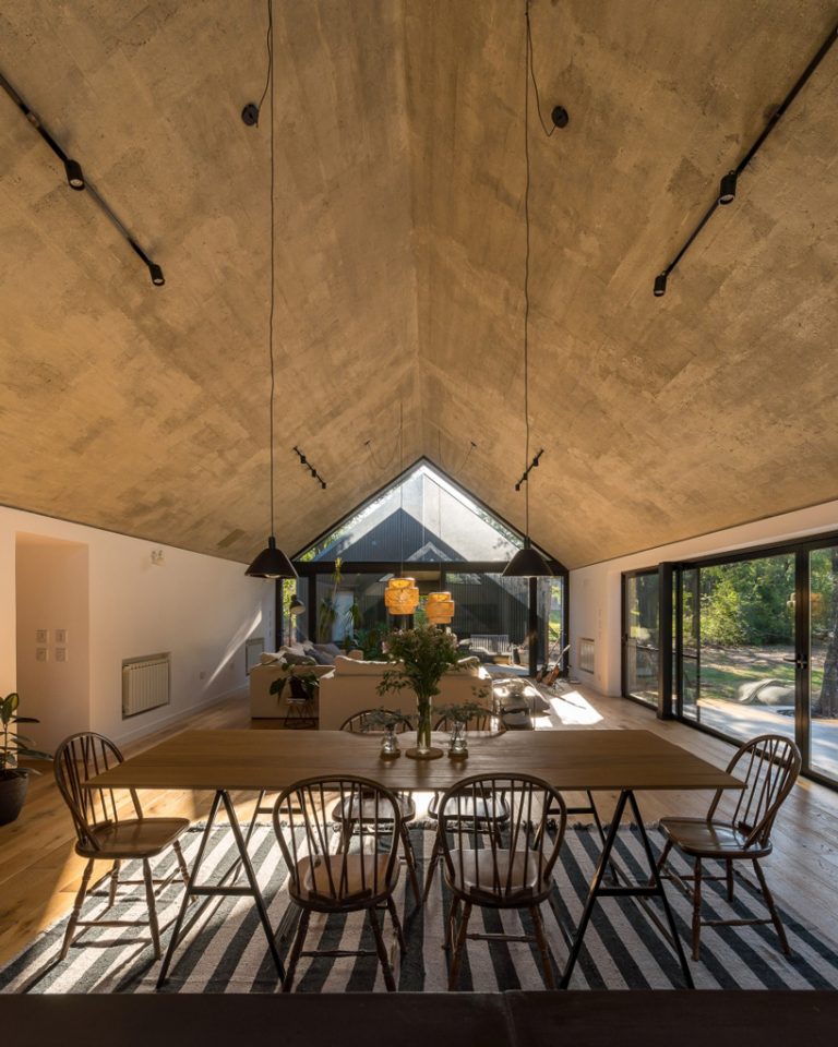 morini black house, 'la negrita,' is nestled among a forest in argentina