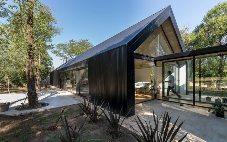 morini black house, 'la negrita,' is nestled among a forest in argentina