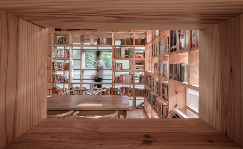 suspended wooden book house is clad in translucent panels by shulin ...