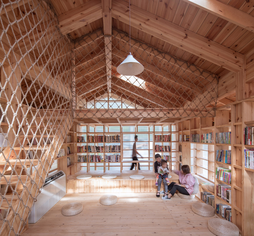 suspended wooden book house is clad in translucent panels by shulin ...
