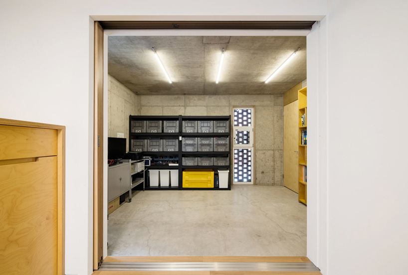 vertically stacked five-story house by stpmj is wrapped in a red brick ...