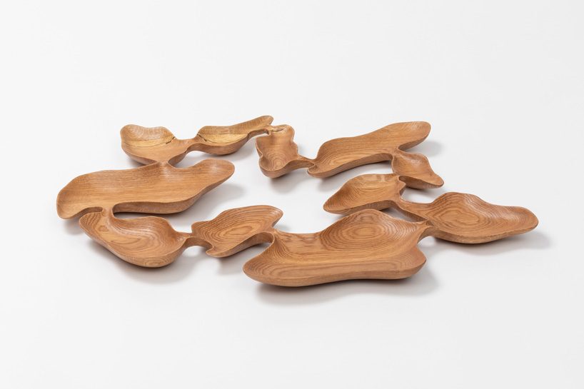 kim yun-hwan composes furniture pieces using hand-carved wood