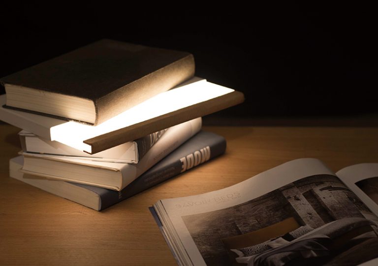 night book emits warm, soft light when pulled from bookcase