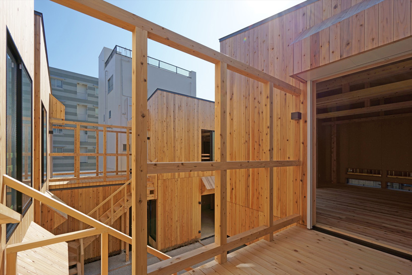 yuji tanabe builds commercial block of twin wooden buildings in japan