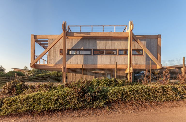 a detached latticed structure wraps around tacna house by par arquitectos