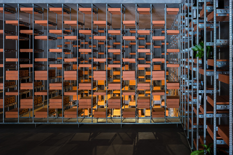 tropical space constructs vietnamese showroom with clay brick + metal ...