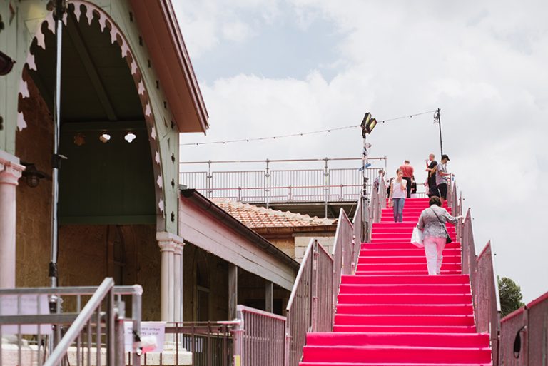 a pink staircase reorients this historic hospital in jerusalem to face ...