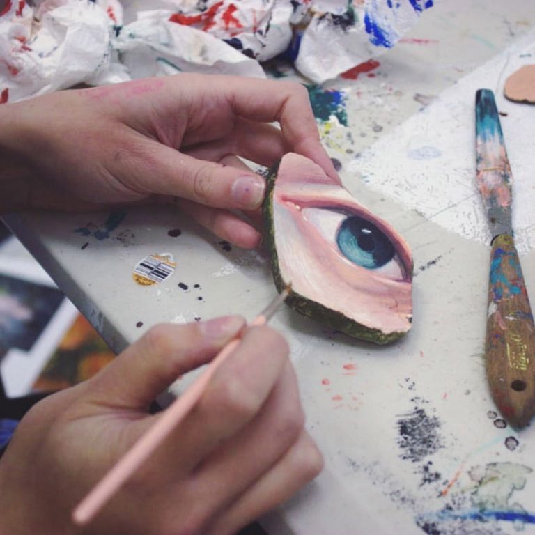 artist paints eyes on stones and then returns them to the place where ...