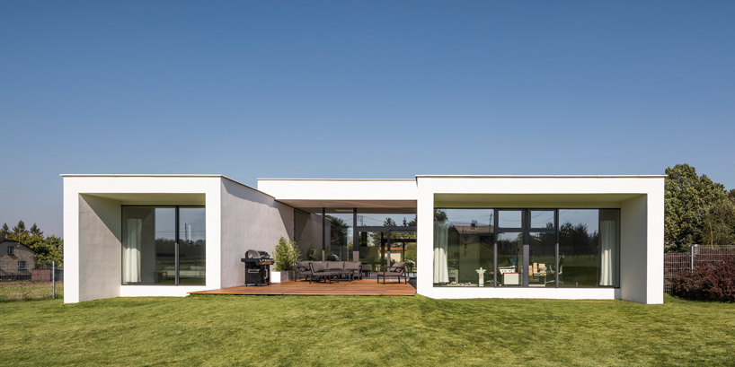 toprojekt's polish residence doubles as a barrier that blocks highway noise