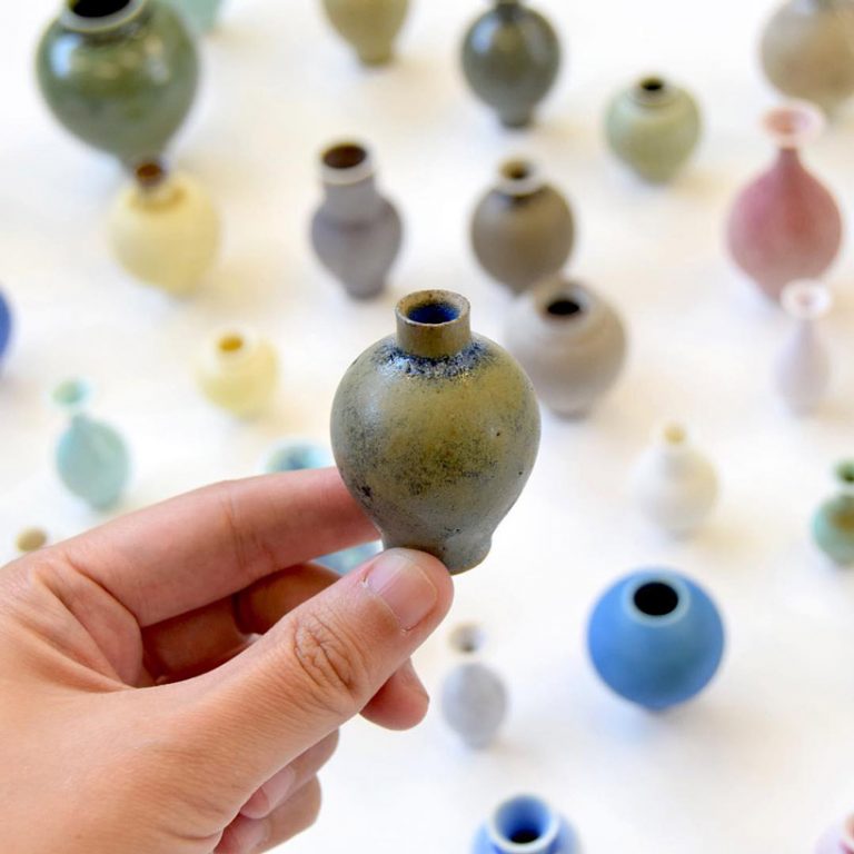 artist yuta segawa hand-throws thousands of tiny ceramic vases