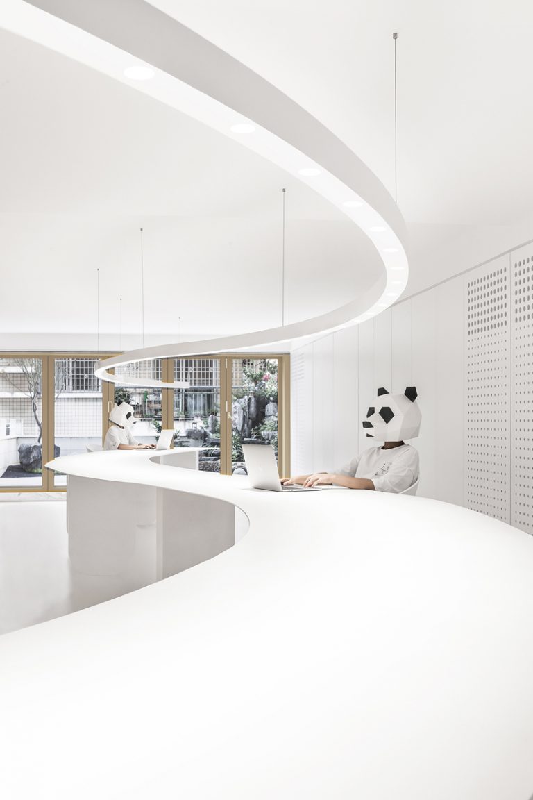 panda design builds a new office around a curved workspace in xiamen