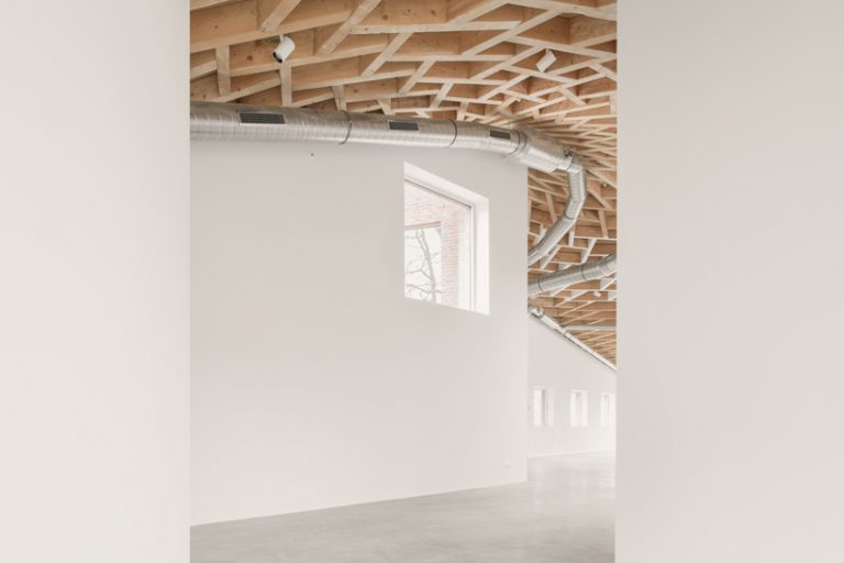 a conic roof of complex timber tops frans masereel centrum in belgium
