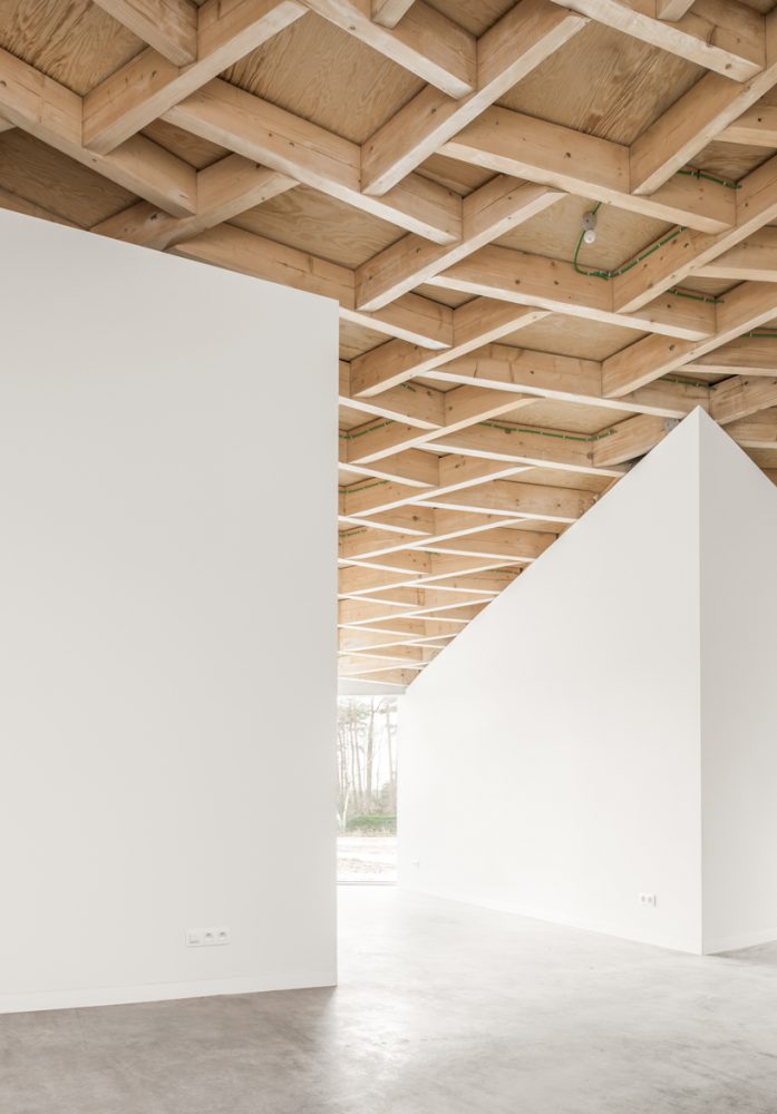 a conic roof of complex timber tops frans masereel centrum in belgium