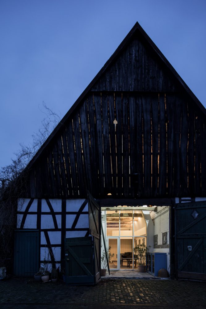 sigurd larsen sets dortmannhof house inside 200-year-old barn in germany