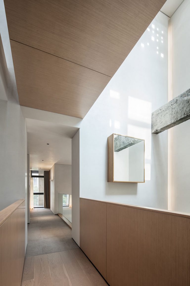 liang architecture inserts a light-filled atrium into apartment in china