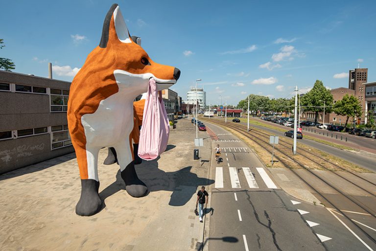florentijn hofman's gigantic fox wanders through grey streets of rotterdam