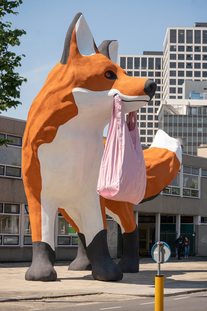 florentijn hofman's gigantic fox wanders through grey streets of rotterdam