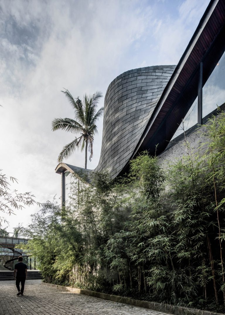 alexis dornier tops 'alpha house' in bali with sculptural, undulating roof