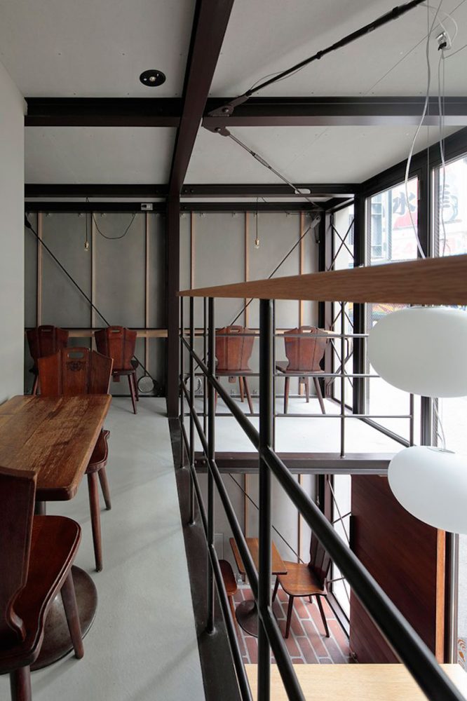 steel H-beams build coffee shop situated under railway elevated bridge ...