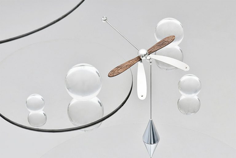 this dragonfly diffuser set balances on its beak while spreading gentle ...
