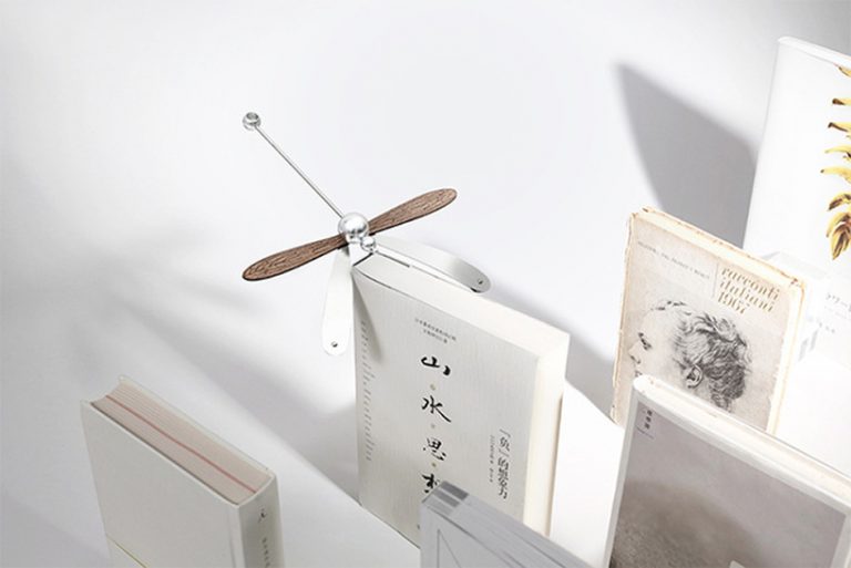 this dragonfly diffuser set balances on its beak while spreading gentle ...