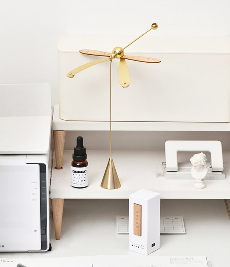 this dragonfly diffuser set balances on its beak while spreading gentle aromas