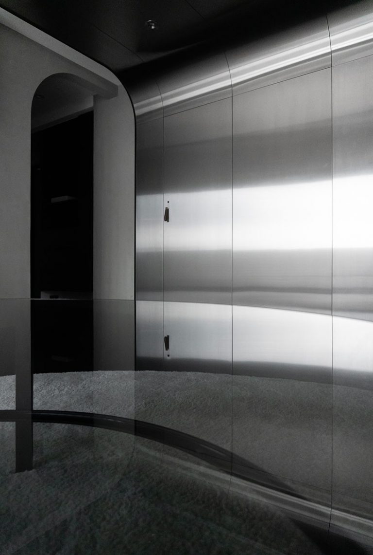 stainless steel wall reflects daily life within minimalist interior by ...