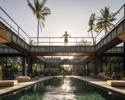 stilt studios' wooden treehouse C hovers above blooming garden in bali