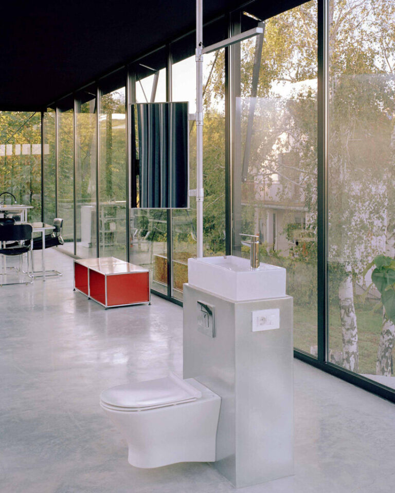 TEN studio sets steel-frame house atop two boulder-like concrete ...