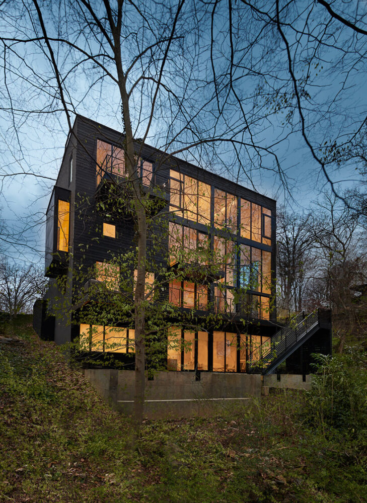 robert gurney architect's luminous facade opens toward its forested site