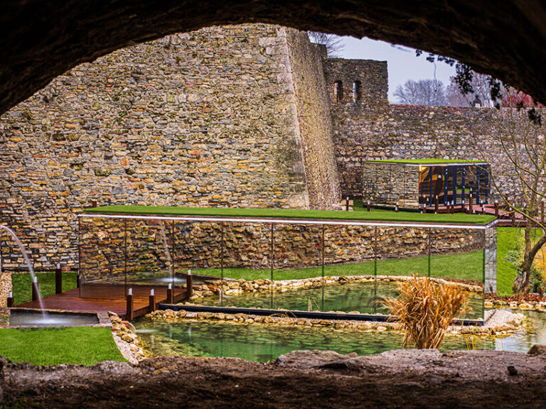 zoltan varro's mirrored spa occupies a 14th century moat in hungary