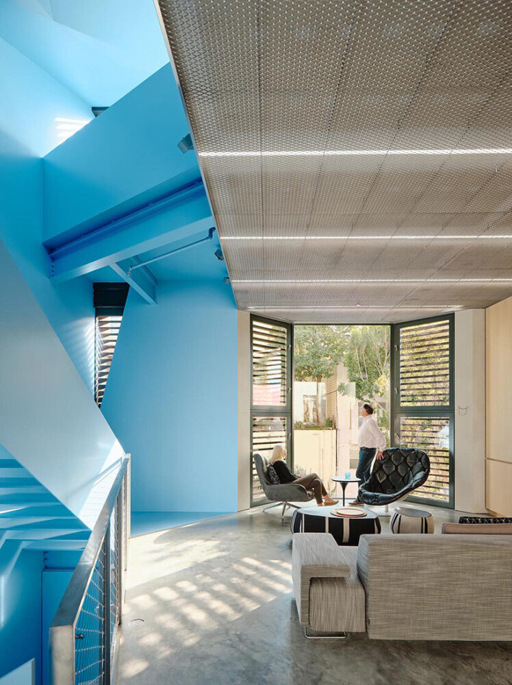 vibrant blue interior peeks through dense facade in san fransisco ...