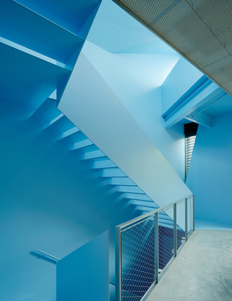 vibrant blue interior peeks through dense facade in san fransisco ...