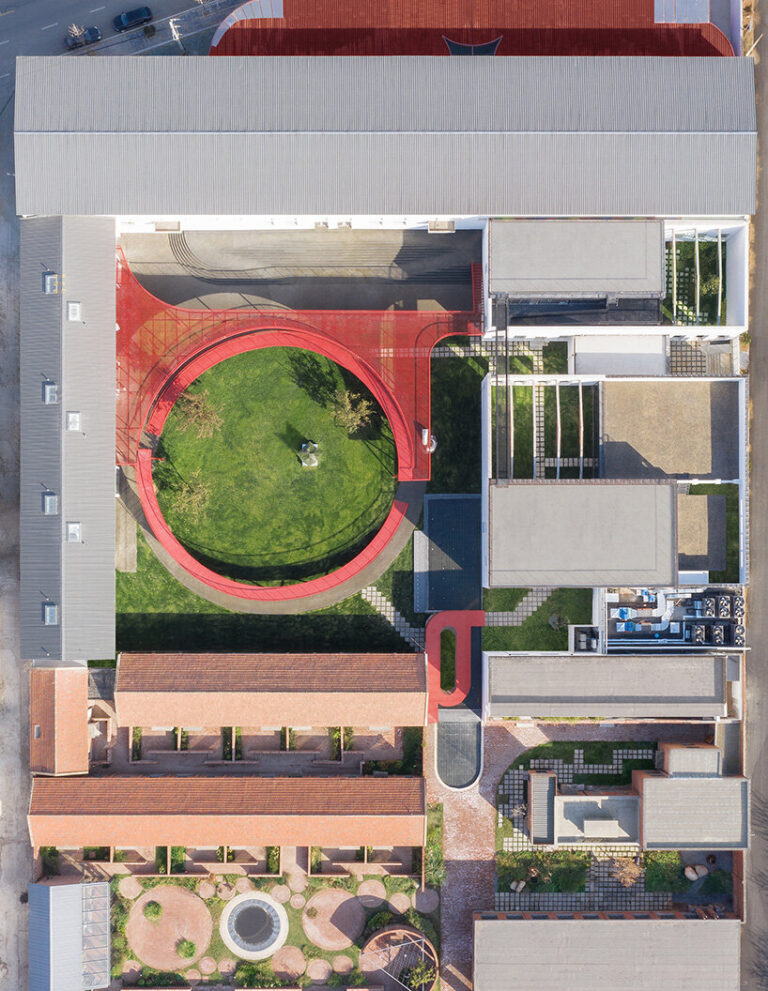 playful red platform encircles renovated youth activity center in china