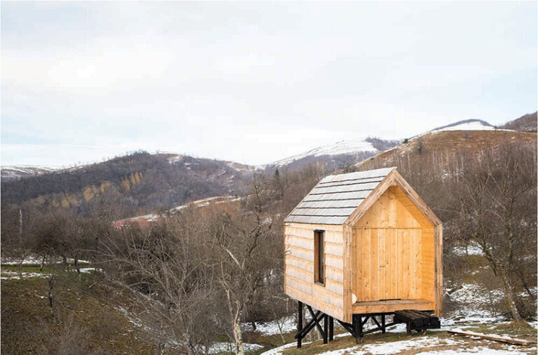 wood + shingle muma hut built by romanian volunteers encourages locals ...