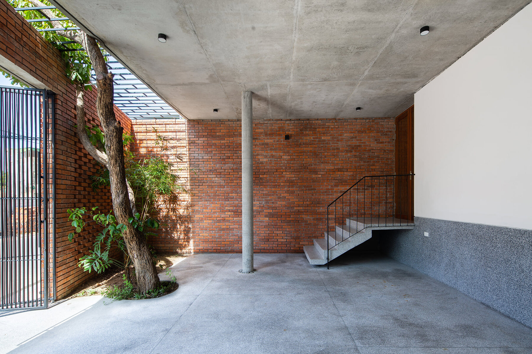 dom architect studio incorporates nature into brick-clad house in vietnam