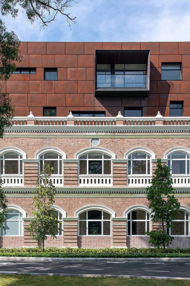 corten steel mass rises up from a colonial building's restoration in ...