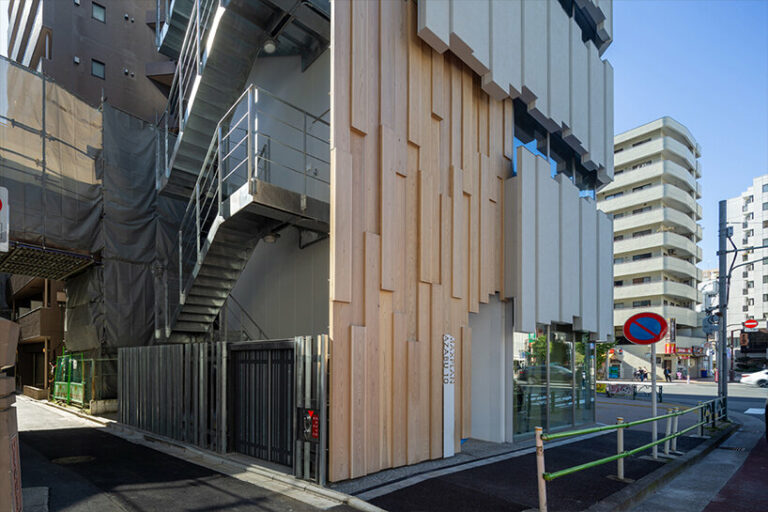 kengo kuma wraps corner building in tokyo with vertical concrete panels