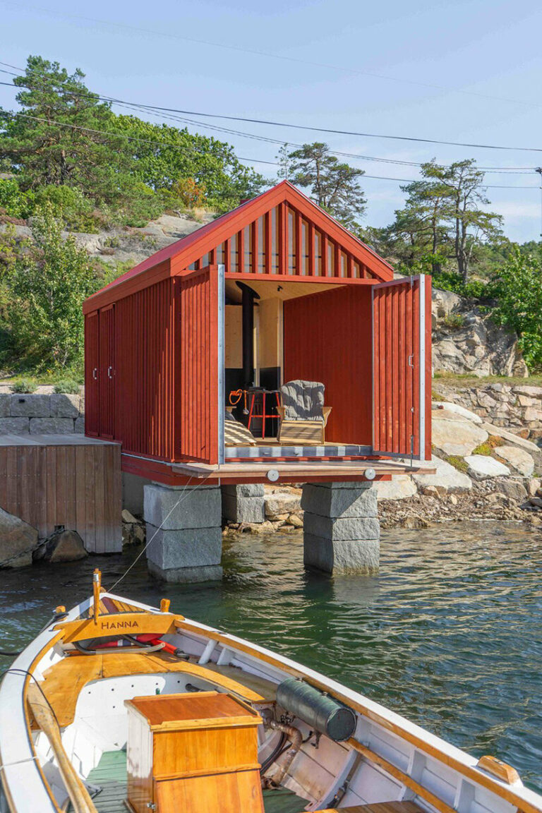 tiny red boathouse by handegård arkitektur settles in small norway harbor