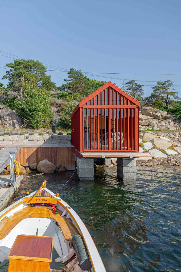 tiny red boathouse by handegård arkitektur settles in small norway harbor