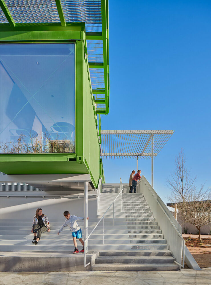mark odom creates vibrant public space with shipping containers on stilts