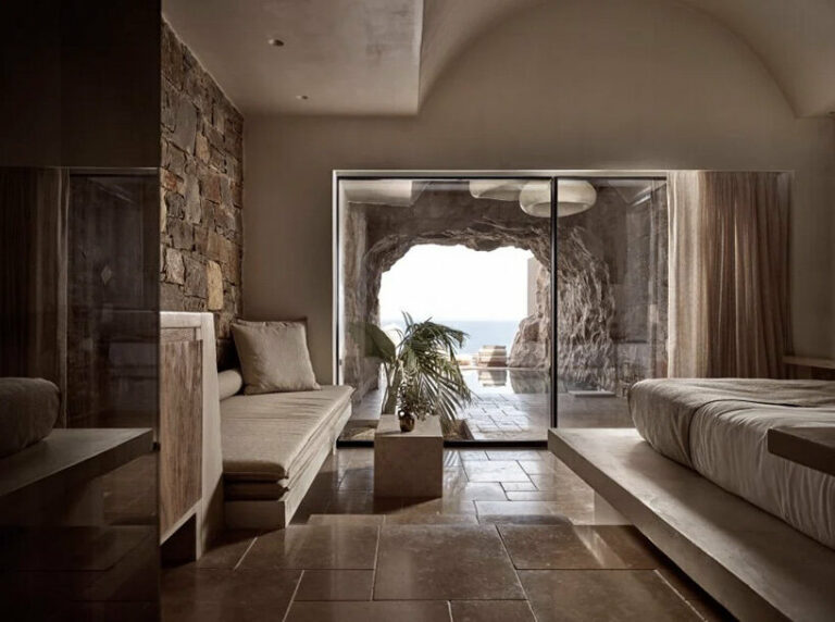 'acro suites' occupies carved-out caves along the coastal cliffs of crete