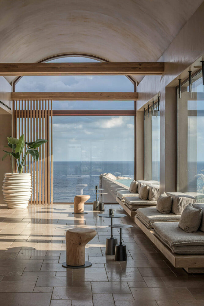 'acro suites' occupies carved-out caves along the coastal cliffs of crete