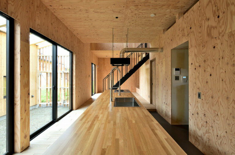 ryuji yamashita divides a building into two for its 'garage house' in japan