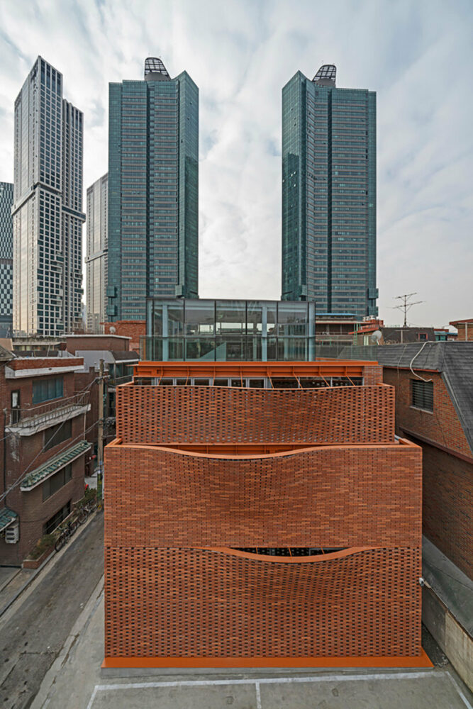 undulating red brick facade envelops 'wave' commercial building by JYA ...