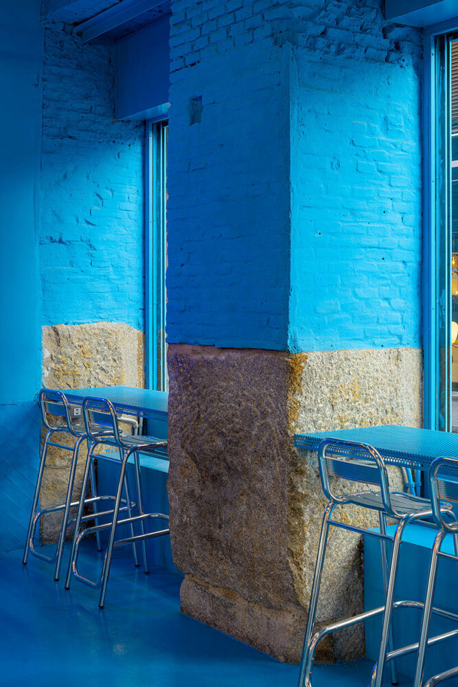 circular 'sun' lamp illuminates blue brando ice cream shop in madrid