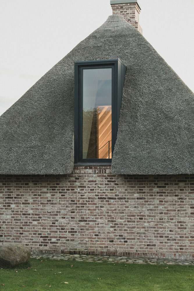 thatched brick 'nieby crofters cottage' revived with glass renovation